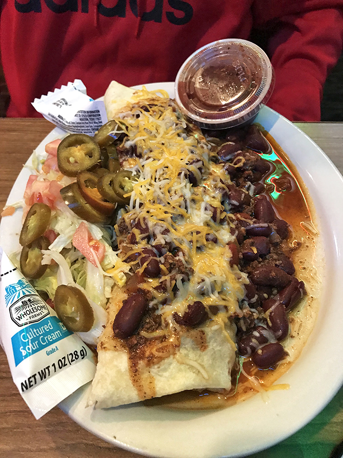 This burrito, smothered in chili and cheese, isn't just a meal&mdash;it's a commitment, a relationship, and possibly a nap afterward.