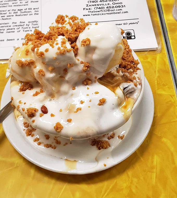 A sundae so magnificent it deserves its own ZIP code. The caramel cascades like a sweet waterfall over mountains of vanilla bliss.