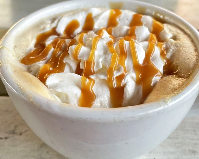 A caramel-drizzled coffee creation that makes you wonder why you ever settled for ordinary lattes. The whipped cream mountain alone deserves its own zip code. 
