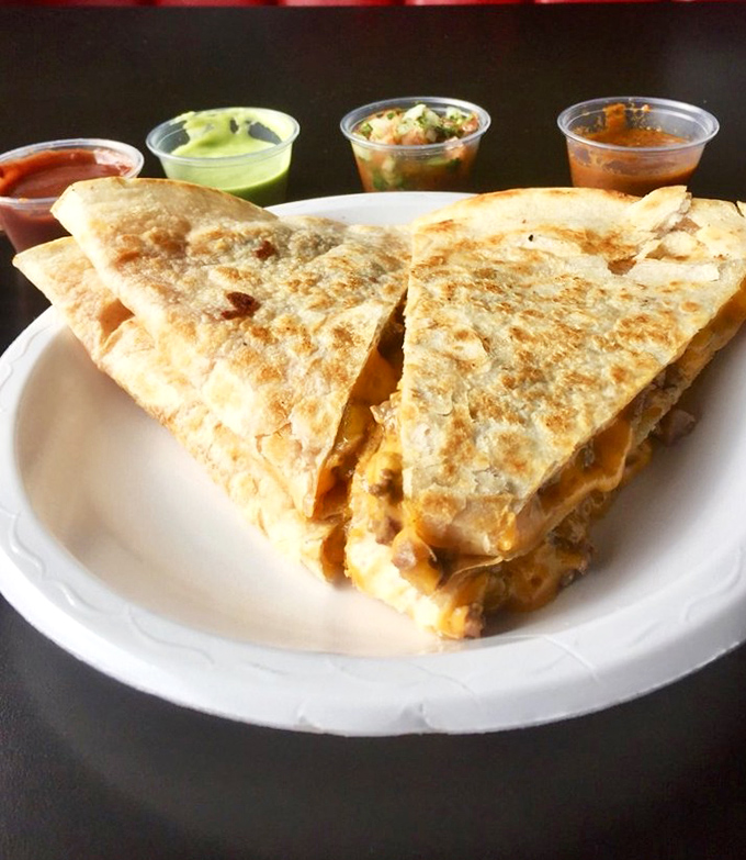 This quesadilla isn't just grilled – it's transformed into a golden-brown envelope delivering cheesy, meaty joy straight to your soul.