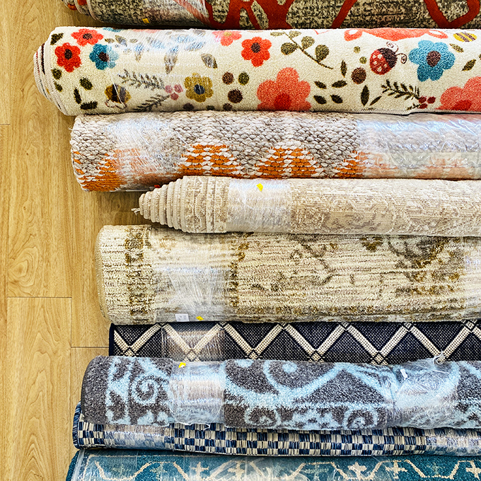 Rolled rugs tell stories of past lives while awaiting new floors to grace&mdash;each pattern a conversation starter for your next dinner party.