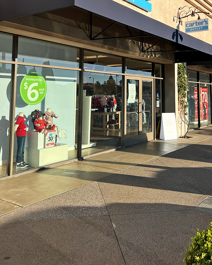 Carter's window display promises adorable outfits at prices that won't make parents weep. Because kids grow faster than your credit card can recover.