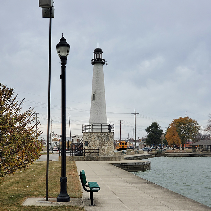 The lighthouse stands sentinel over Grand Lake St. Marys, a landlocked beacon that somehow makes perfect sense in this lakeside community.