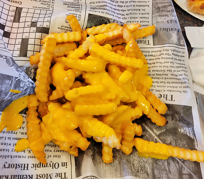 Waffle fries drowning in melted cheese because sometimes you need to embrace the glorious excess of American comfort food.