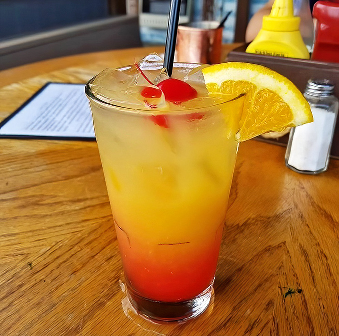 The Chesapeake Bay Sunset cocktail&mdash;where fruit juice meets vacation vibes. One sip and you're mentally collecting seashells, regardless of your actual plans.