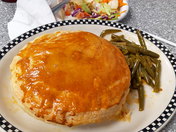 Beneath that golden dome of pastry lies a chicken pot pie so comforting, it's like a warm hug from your favorite aunt who really knows how to cook.