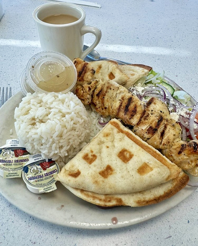 This chicken souvlaki plate brings Mediterranean sunshine to upstate New York, with rice so fluffy it could double as a pillow.