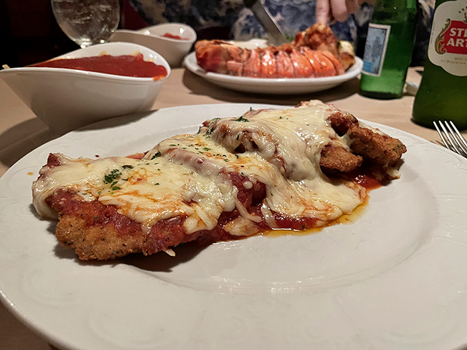 The legendary chicken parmesan in all its glory &ndash; crispy, saucy, cheesy, and absolutely worth crossing state lines for without a moment's hesitation.