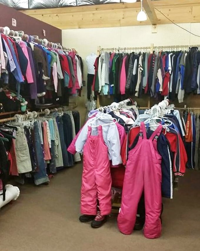 Pink snow pants hanging like exclamation points among everyday clothes. Wisconsin parents know: growing kids need winter gear that won't break the bank.