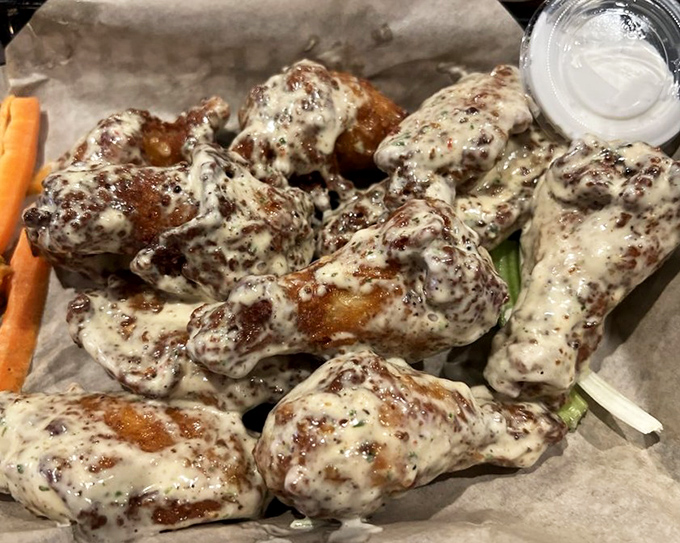 Wings wearing a coat of what appears to be ranch mixed with pure happiness and maybe some chipotle magic.