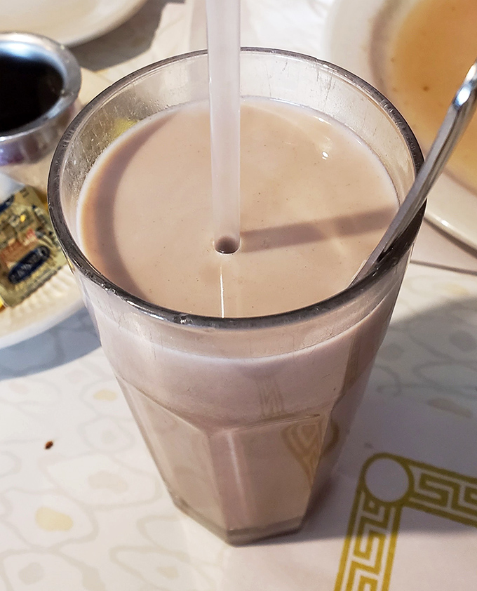 Chocolate milk in a classic diner glass &ndash; proof that some childhood pleasures actually get better when you're old enough to order them yourself.
