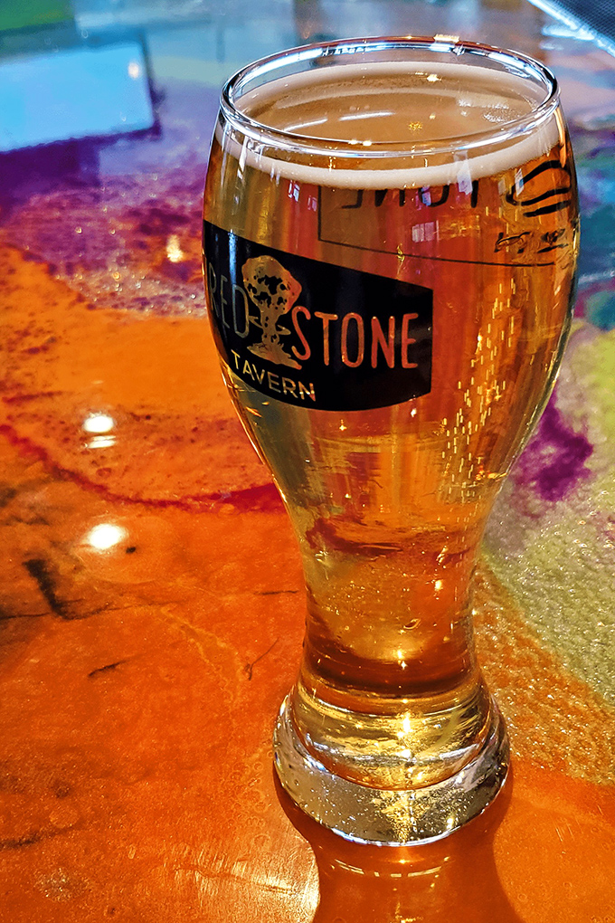 A perfectly poured beer in custom glassware, where the amber liquid catches the light like Ohio sunshine through autumn leaves.