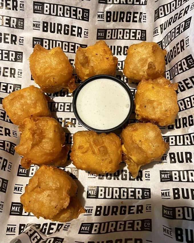 Wisconsin cheese curds arranged in a perfect circle, like a deep-fried solar system orbiting that dipping sauce sun. Resistance is futile.