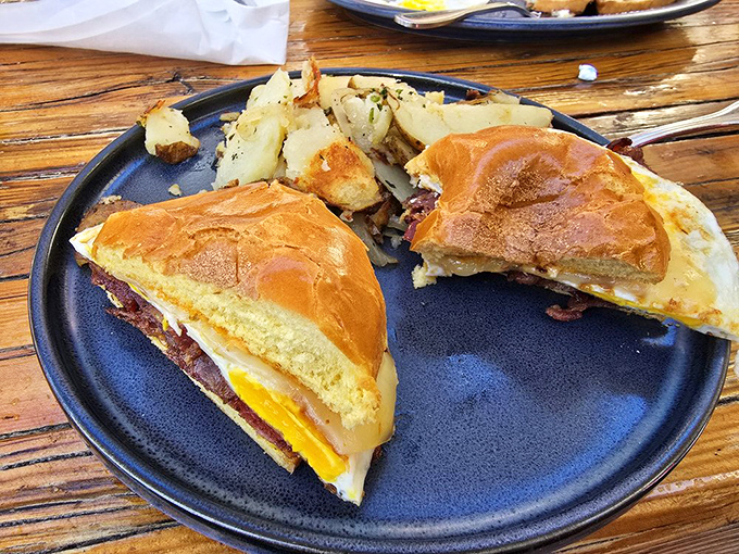 The breakfast sandwich reimagined: eggs, cheese, and meat nestled between bread that clearly went to finishing school, served with perfectly seasoned potatoes.