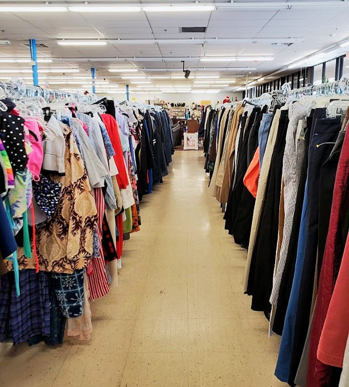 The clothing corridor stretches like a runway of possibilities, each hanger holding someone's former fashion statement.