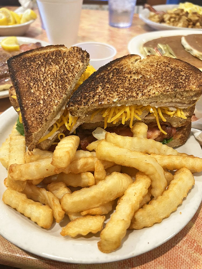 A proper club sandwich with crinkle-cut fries &ndash; the lunch equivalent of a warm hug from your favorite aunt.