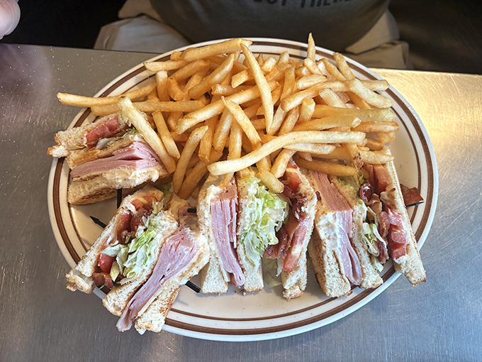 A club sandwich with fries that stands tall and proud, like the Washington Monument but infinitely more delicious.