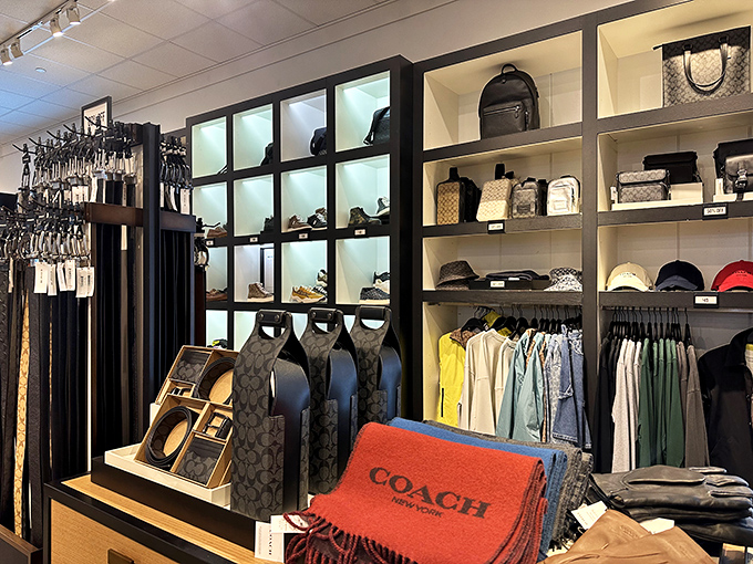 Coach's meticulous displays elevate outlet shopping from bargain hunting to luxury experience. The lighting alone deserves its own Instagram account.