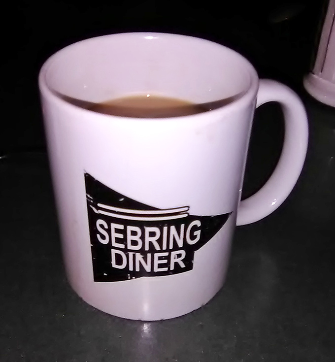 The coffee mug says Sebring Diner, but what it really means is "I'm going to be refilled at least three times while you solve all the world's problems."