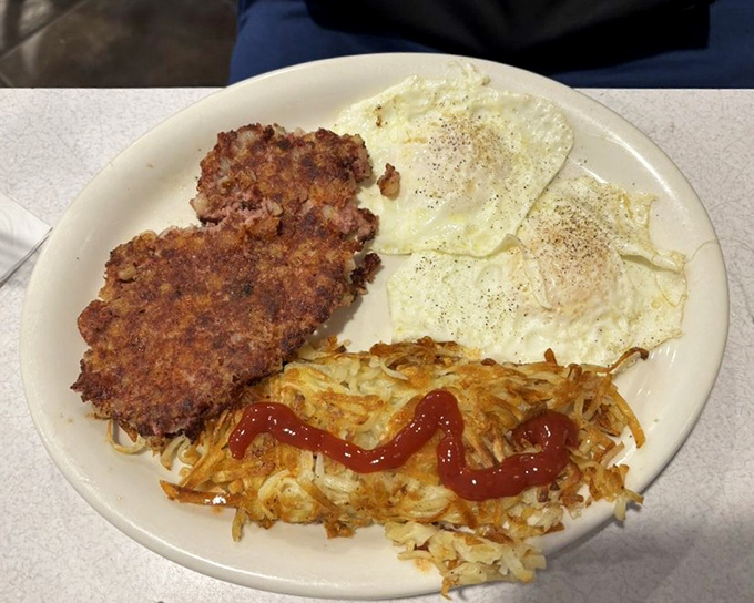 Crispy corned beef hash with eggs sunny-side up &ndash; breakfast's dynamic duo. The kind of plate that makes you want to high-five the cook.