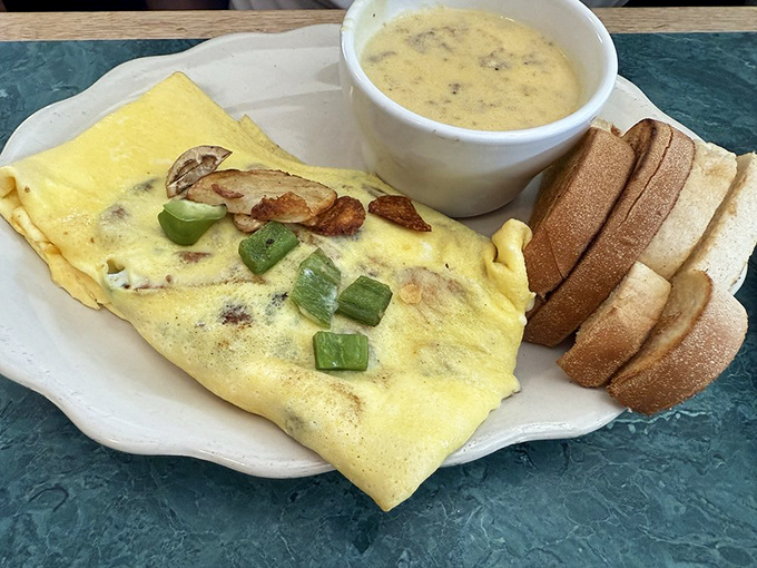 This isn't just an omelet; it's a morning masterpiece where farm-fresh eggs meet perfectly saut&eacute;ed mushrooms in a dance of breakfast perfection.