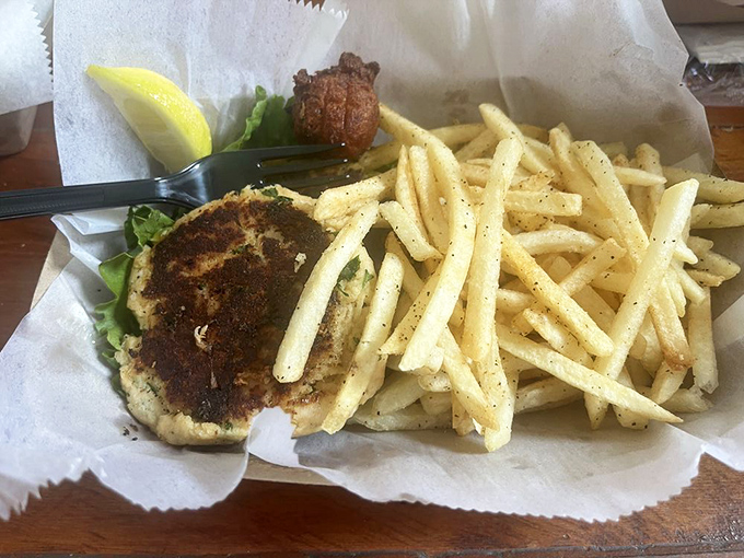 This crab cake isn't just a meal; it's a declaration that sometimes the best things in life come on wax paper with a side of fries.