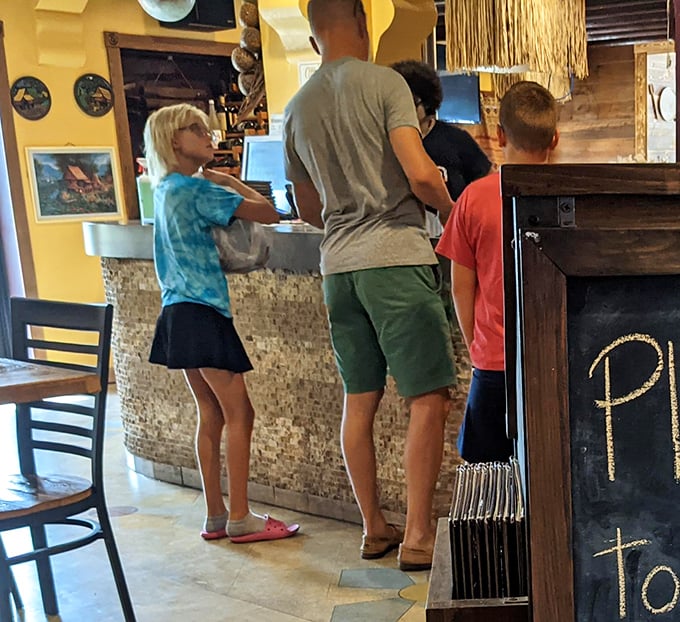 Families gather at the counter, drawn by aromas and reputation, about to discover why this unassuming spot has become a Lima institution.