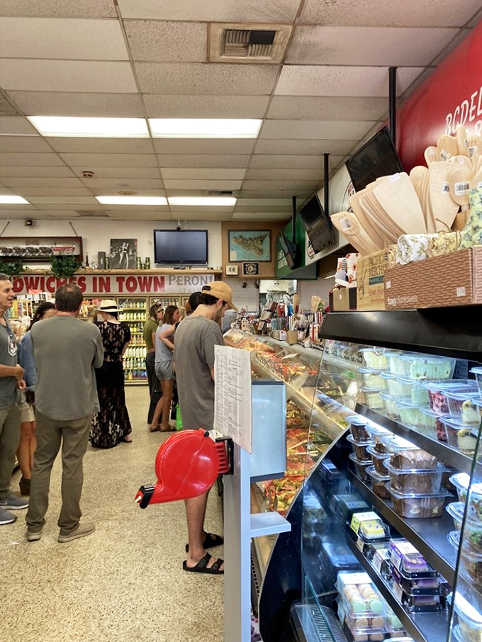 The line at Bay Cities moves with the organized chaos of a symphony—everyone knows their part in the dance toward deliciousness.