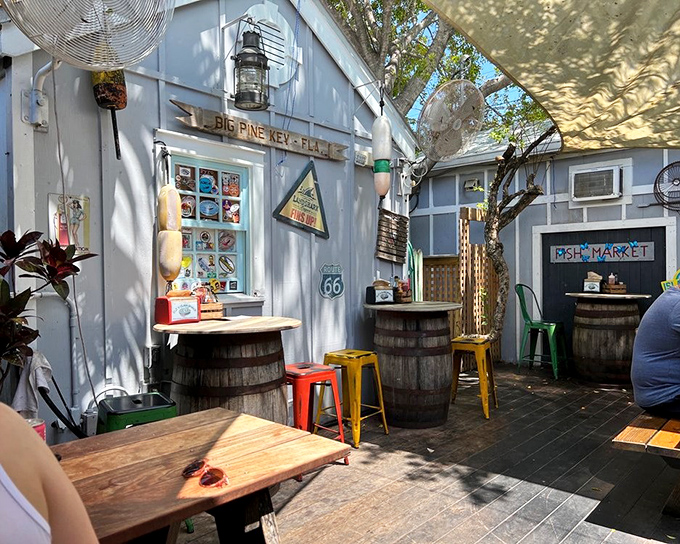 A slice of Old Florida charm under the shade sails&mdash;where barrel tables and colorful stools create the perfect seafood sanctuary.