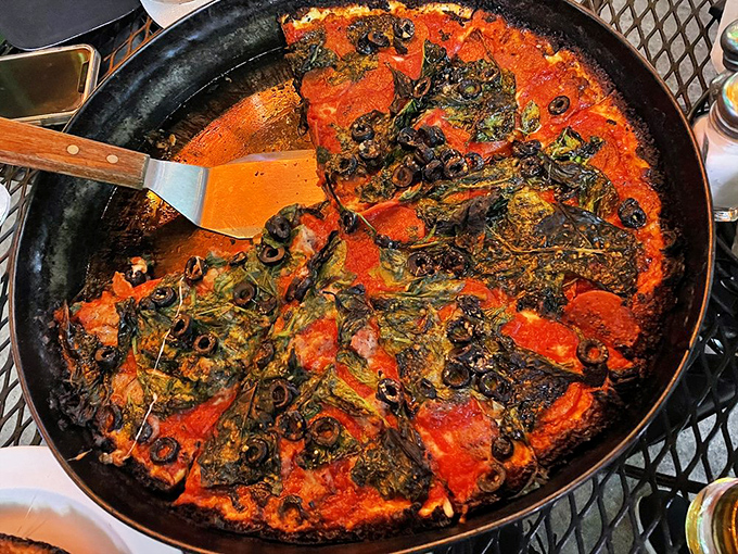 The spatula reveals the true depth of this deep dish creation&mdash;layers of ingredients that require engineering as much as cooking.