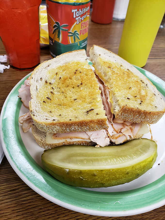 A turkey sandwich that proves simplicity is the ultimate sophistication—especially when paired with that pickle spear of perfection.