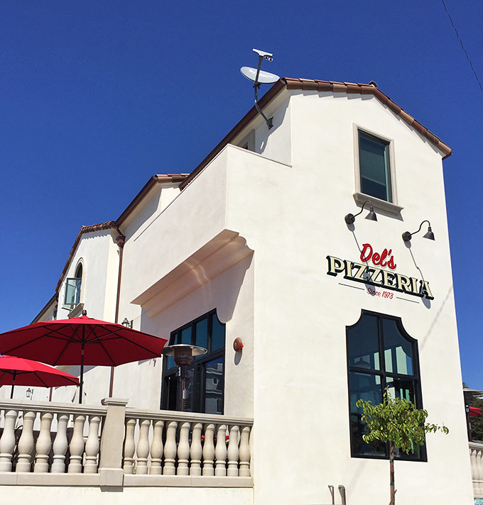 Del's Pizzeria's Mediterranean-style building promises the kind of neighborhood Italian spot where the owner might still remember your name and order.