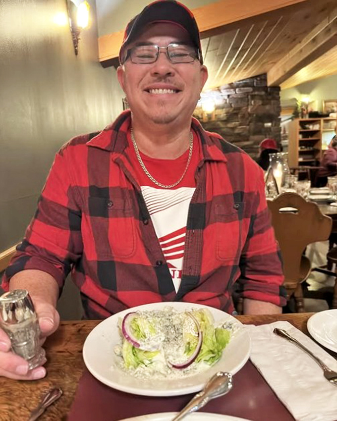 Nothing says "I'm enjoying my meal" quite like a genuine smile and a wedge salad. Pure steakhouse contentment captured in one frame.