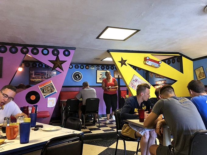 Diners enjoy the full Zodiac experience surrounded by colorful angular walls and vintage record decorations. Breakfast as performance art.