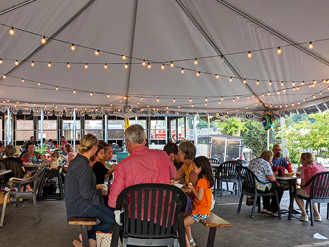 The outdoor tent dining area buzzes with conversation and laughter&mdash;proof that great food brings people together better than any fancy d&eacute;cor.