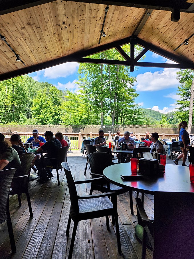 Vaulted ceilings with exposed beams and deer mounts create the quintessential Appalachian dining experience. Families gather beneath the rustic chandeliers.
