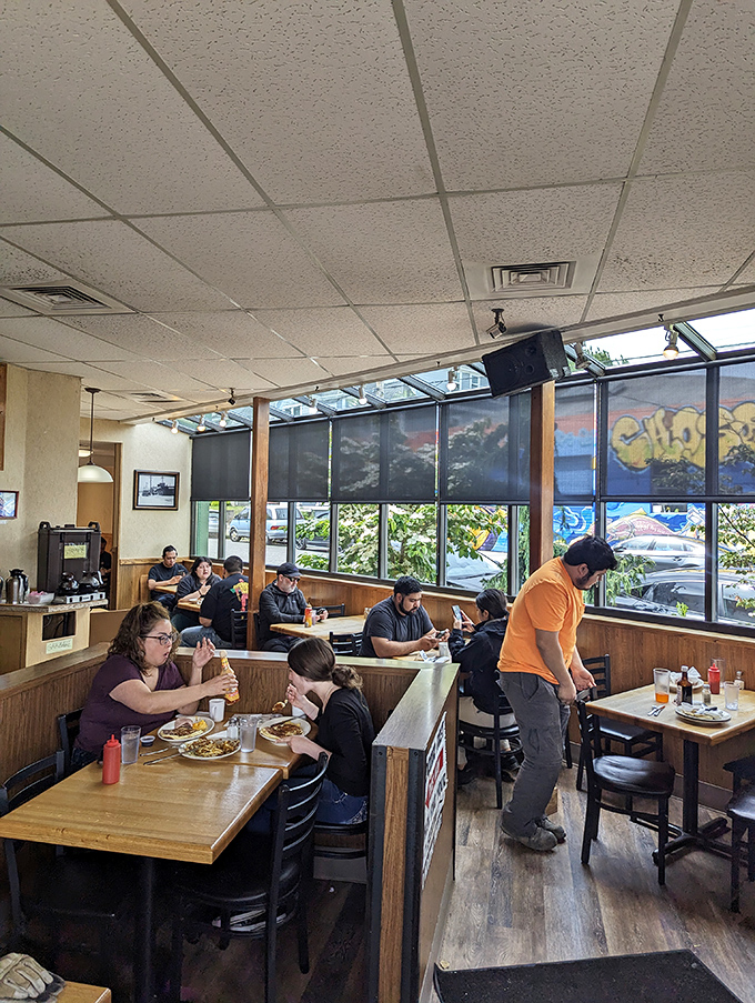 The dining room—where strangers become temporary breakfast companions united by the universal language of "pass the syrup, please."
