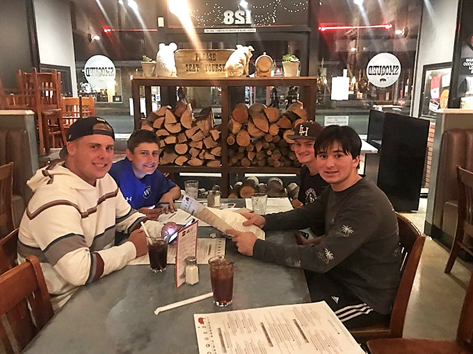 Young diners discovering that real barbecue beats drive-through burgers by approximately seventeen thousand delicious miles and counting here.
