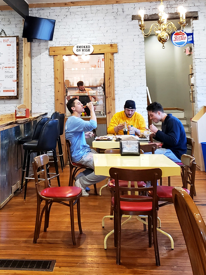 Nothing says "we made the right lunch decision" like friends gathered around yellow tables, celebrating the universal language of great BBQ.