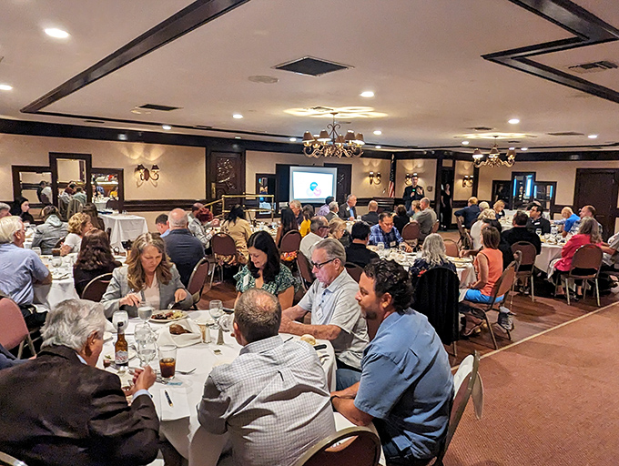 Happy diners engaged in that universal language: the appreciation of a great meal shared. Conversations flow as freely as the wine.