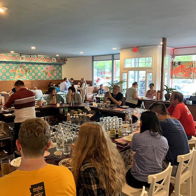 The communal dining experience at Gado Gado turns strangers into friends, united by the universal language of "pass that dish, please!"