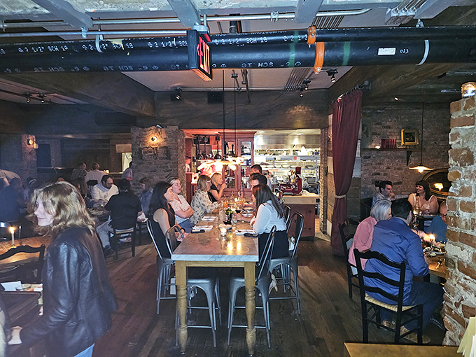 The communal table at Sotto buzzes with the energy of shared culinary discoveries. Strangers become friends over plates of pasta and glasses of wine.