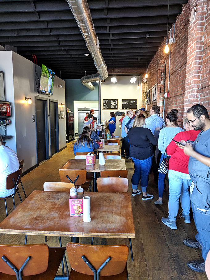 The line forms early and with good reason. These barbecue pilgrims know that patience is rewarded with smoky perfection.