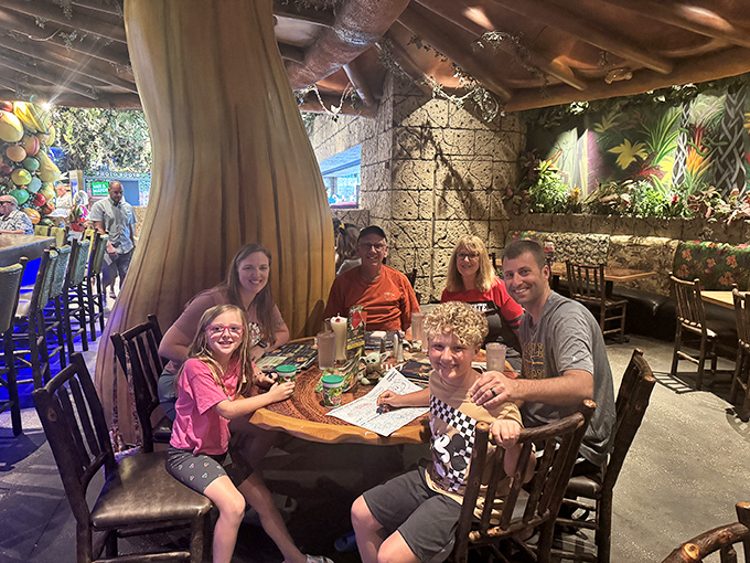 Families create memories that last longer than the meal itself, surrounded by the gentle glow of a jungle that never needs bug spray.