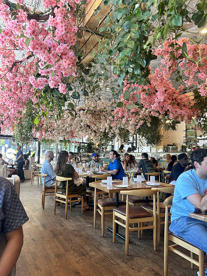 The restaurant buzzes with the energy of shared plates and conversation. Under those pink blossoms, strangers become friends and calories don't count.