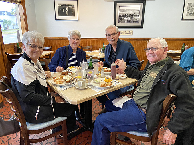 Happy diners sharing stories over seafood. Some restaurants feed your body; the special ones nourish your soul too.