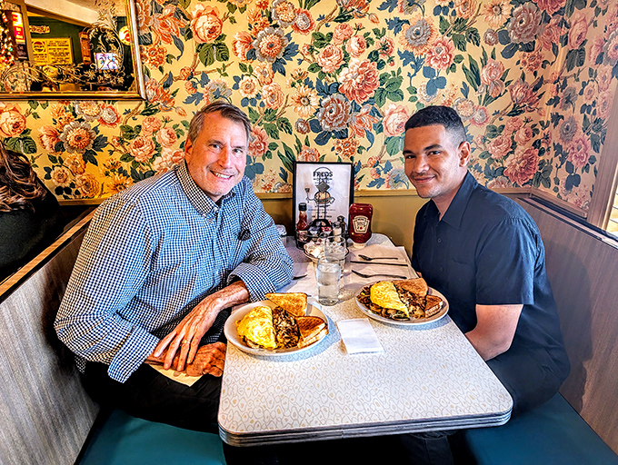 Two happy diners enjoying the fruits of Fred's kitchen labor&mdash;those plates of breakfast goodness are worth smiling about.