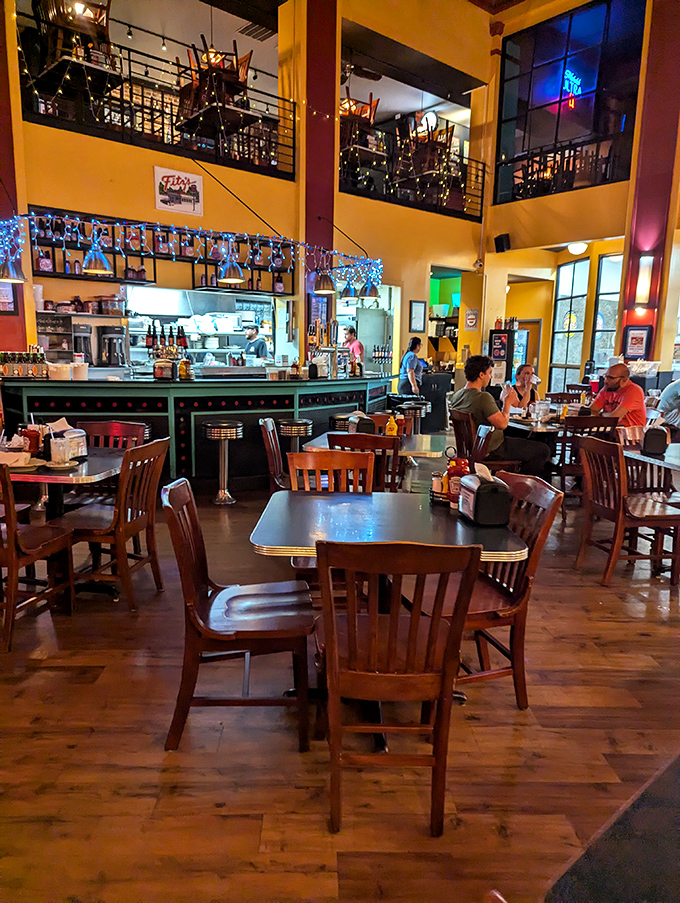 Families and friends gather under soaring ceilings and brick walls, creating that perfect buzz of conversation that makes dining out feel like a special occasion.