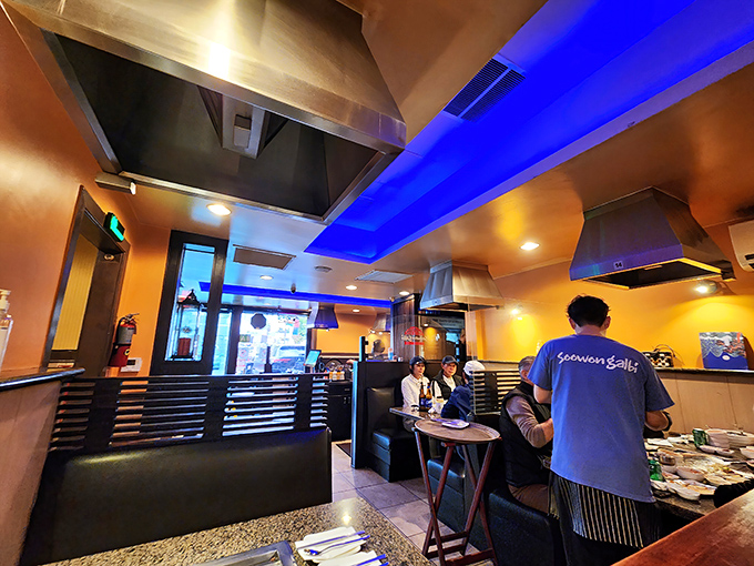 Blue accent lighting adds a modern touch to the warm wood tones, creating an atmosphere that says "serious about food, but still fun."