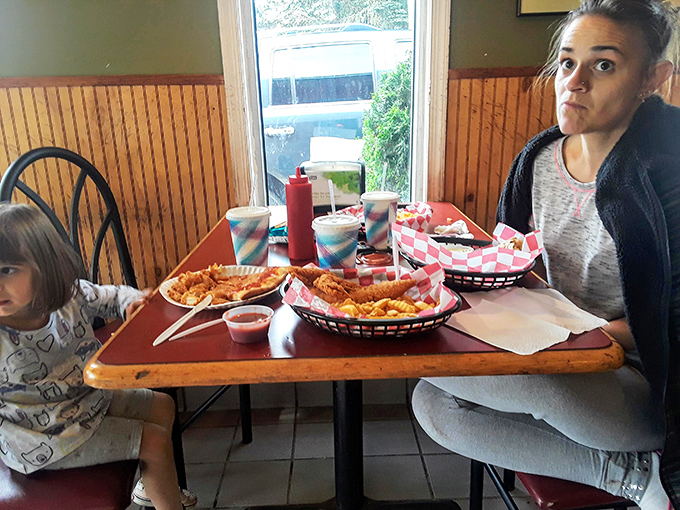Family dining at its most authentic—plastic baskets lined with checkered paper, squeeze bottles of ketchup, and food that brings generations together.